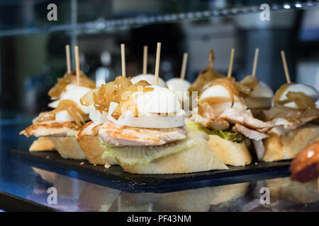 Typical spanish food tapas on a counter in a restaurant Stock Photo - Alamy