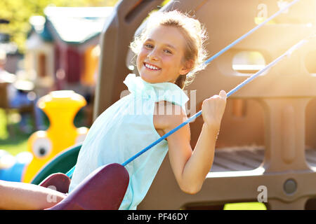 Picture showing joyful girl having fun on playground Stock Photo - Alamy