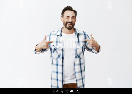 Happy young man with moustache winking and showing thumbs-up ...