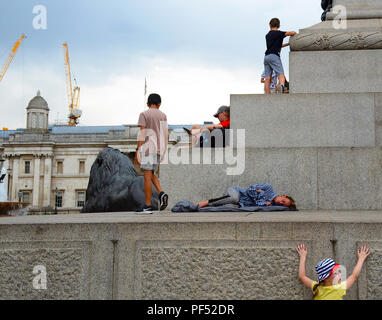 London, UK, 7 August 2018 Homeless man sleeping on the base of Nelson's ...