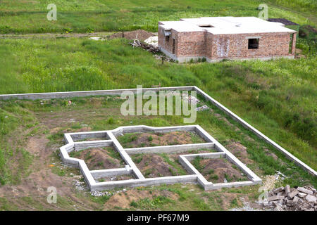 Foundation trench filled with concrete for a building extension on a ...