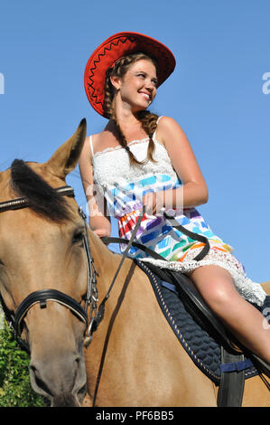 young attractive woman horseback riding Stock Photo - Alamy