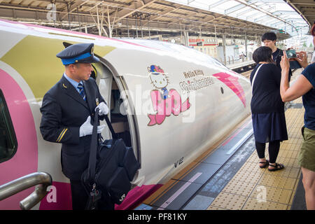 Hello Kitty, in a Japan Rail train conductor uniform, aboard the special Hello Kitty shinkansen ...