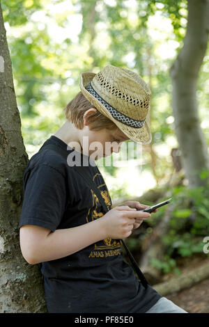Portrait of children playing on mobile phone together at home. Internet ...