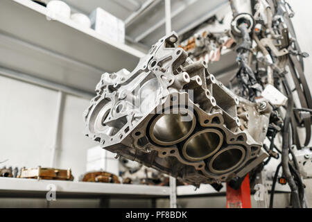 Disassembled engine block is on the table. the mechanic opened the ...