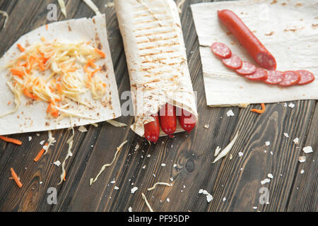 sausages in pita bread on wooden background Stock Photo - Alamy