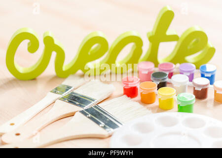 Green create sign with paint brushes on the table Stock Photo - Alamy