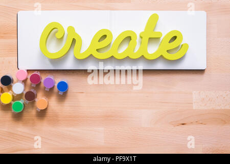 Green create sign with paint brushes on the table Stock Photo - Alamy