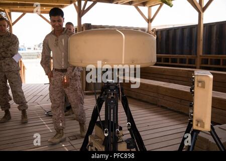 An AN/TRN-47 Tactical Air Navigation (TACAN) system is staged next to ...
