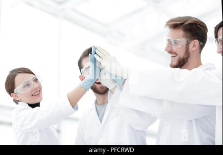scientists giving each other a high five Stock Photo - Alamy