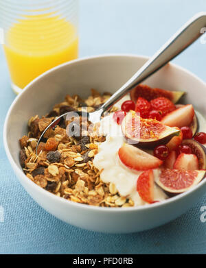 Breakfast with muesli, strawberries, orange juice on the wooden table ...