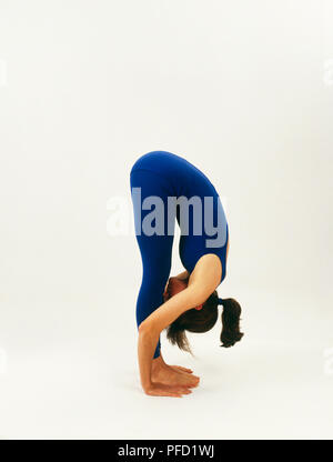 Woman performing standing forward bend Stock Photo: 19181910 - Alamy