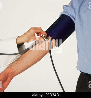 Doctors hand measuring blood pressure of male patient Stock Photo - Alamy