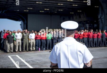 The crew of the aircraft carrier USS MIDWAY (CV-41) mans the rails on ...