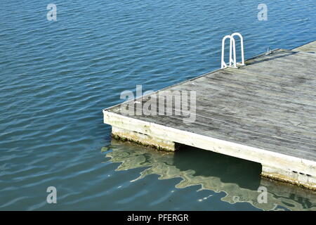 Floating jetty with wooden floor and metal welded cleats and car tyre ...