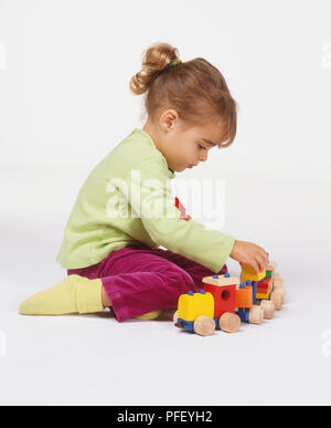 Side view of cute girl playing piano Stock Photo - Alamy