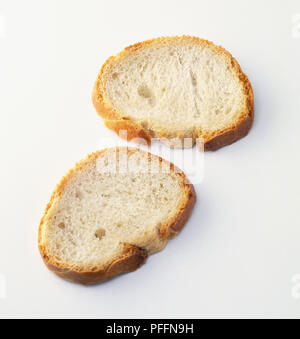 Vertical shot of bread slices on a bowl isolated on a pink background ...