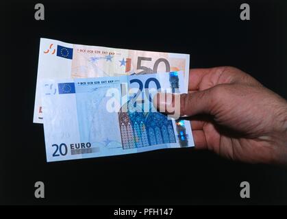Hand holding fifty euro banknote on white background Stock Photo - Alamy