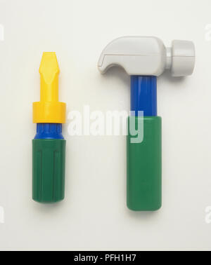blue and yellow toy screwdriver and green screwdriver on a white ...