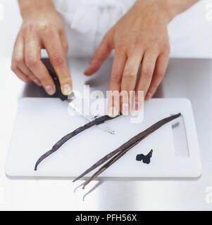 Cooking knife on a cutting board and wooden table Stock Photo - Alamy