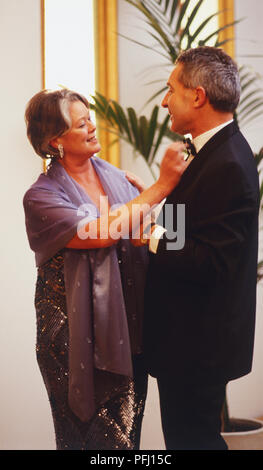 Woman adjusting mans tie Stock Photo - Alamy