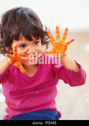 Close up of a person in orange gloves cleaning a dirty oven with a ...