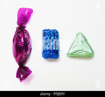 Three wrapped sweets, close up Stock Photo - Alamy