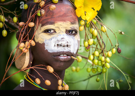 Portrait of young Suri / Surma woman with ritual scarification on chest ...
