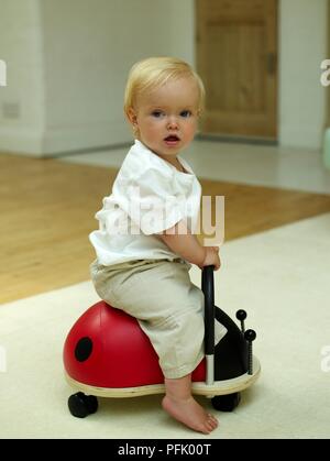 Baby boy sitting in the room Stock Photo - Alamy