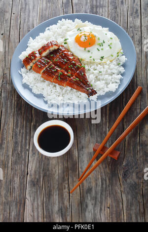 A fish fillet served with brown rice and broccolini Stock Photo - Alamy