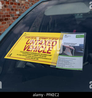 Untaxed Vehicle notice stuck on a car windscreen Stock Photo - Alamy