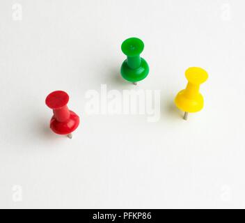 Three drawing pins on a white background Stock Photo - Alamy