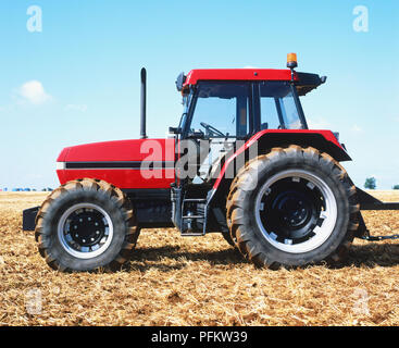 Red tractor in the field Stock Photo - Alamy