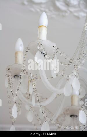 Close up of a chandelier on the ceiling with a traditional oriental ...