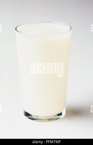 Close up of glass of milk in front of girl Stock Photo - Alamy