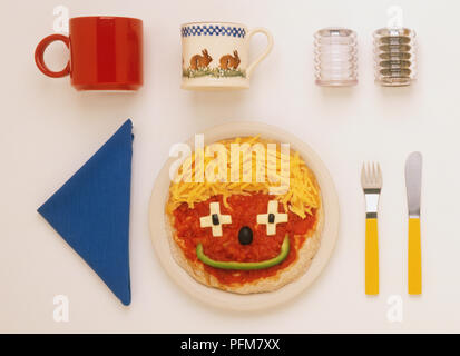 Pizza with fork and knife on a blue wooden table Stock Photo - Alamy