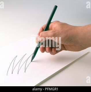 Graphite pencil in human hand. White wall background Stock Photo - Alamy