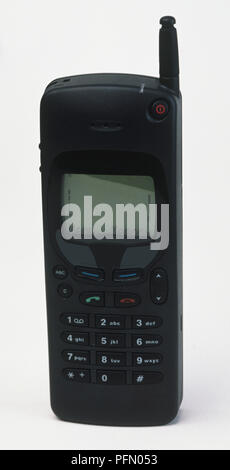 Close up shot of a mobile phone with broken screen on a wooden table ...