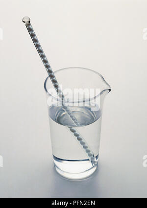 Glass rod refracted in beaker of water Stock Photo - Alamy