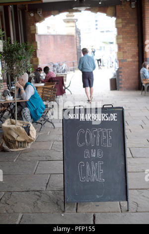 August 2018 - White tables and chairs outside a cafe in an old building ...