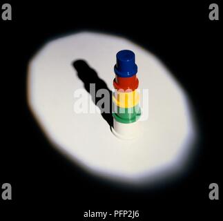 Light illuminating multicoloured object causing black shadow Stock ...