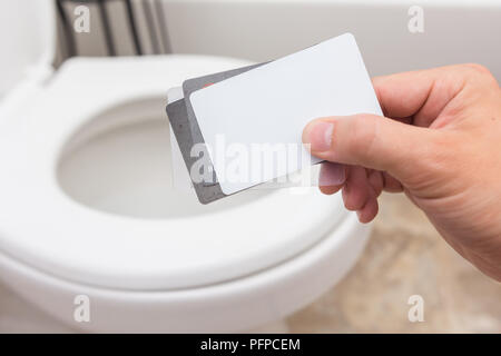 Holding cluster of blank cards (credit card, business card, membership ...