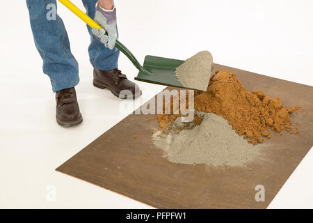 Mixing dry powdered ingredients of cement together Stock Photo - Alamy