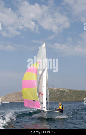 Spain, Minorca, two young women in sailing dinghy, sailing upwind Stock ...