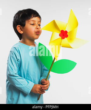 a boy holding a toy windmill Stock Photo - Alamy
