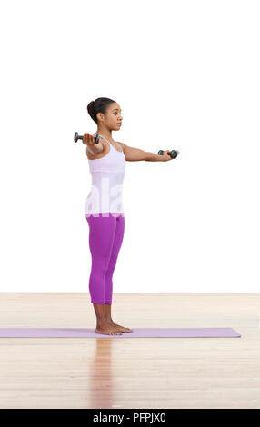 Side view of woman exercising on sports track against clear sky Stock ...
