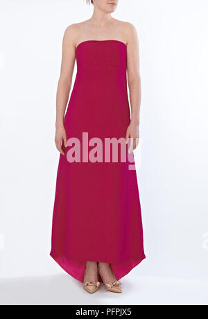 Woman wearing a white strapless dress and hands touching the chin Stock ...