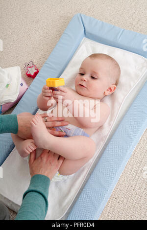 Baby boy having his nappy changed Stock Photo - Alamy