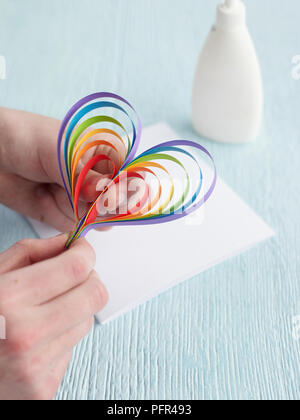 Making a heart card, Bending colourful strips into loops to make heart ...
