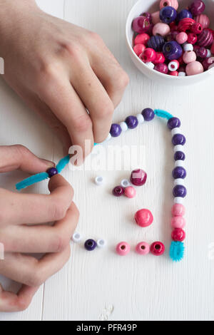 Beads and pipe cleaner Stock Photo - Alamy